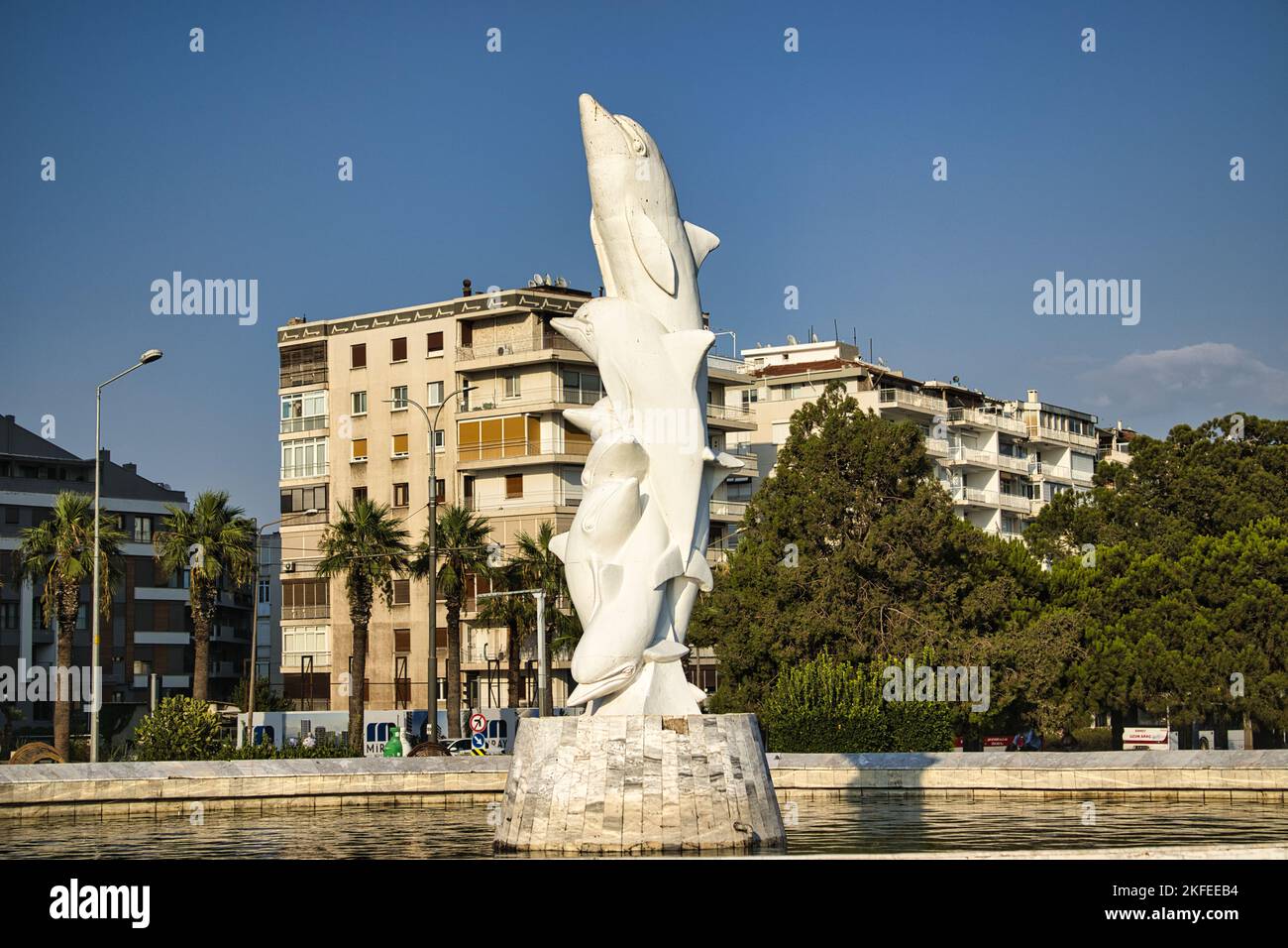 A decorative white dolphin statue in a water fountain in Karsiyaka ...