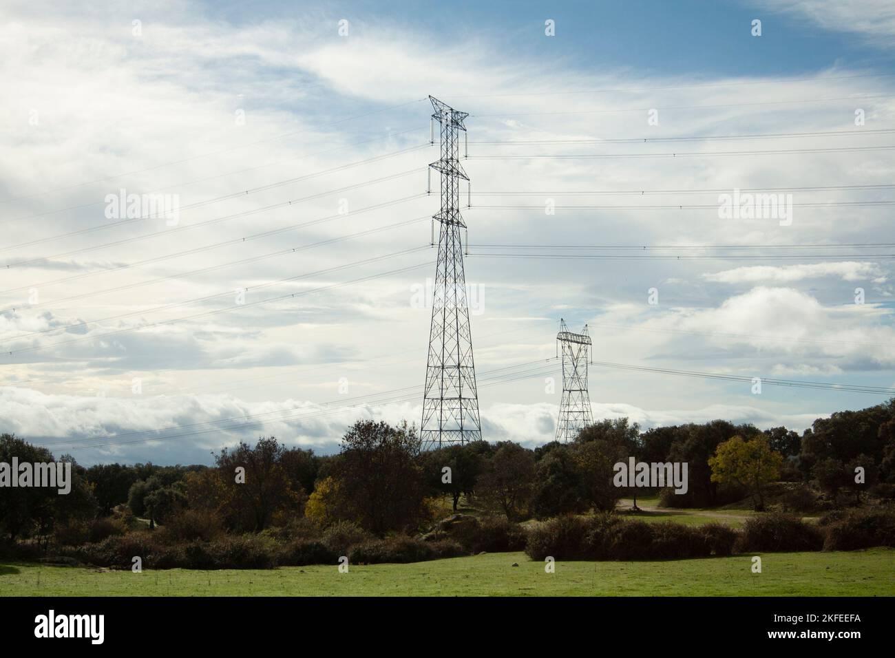 Electric post high voltage tower located along the field until its ...