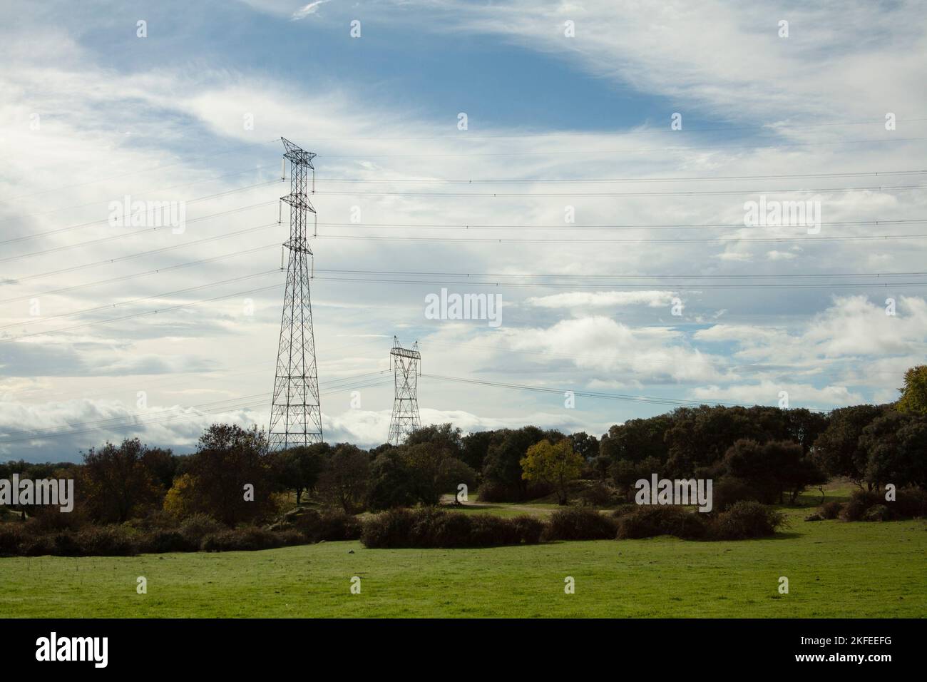 Electric post high voltage tower located along the field until its ...