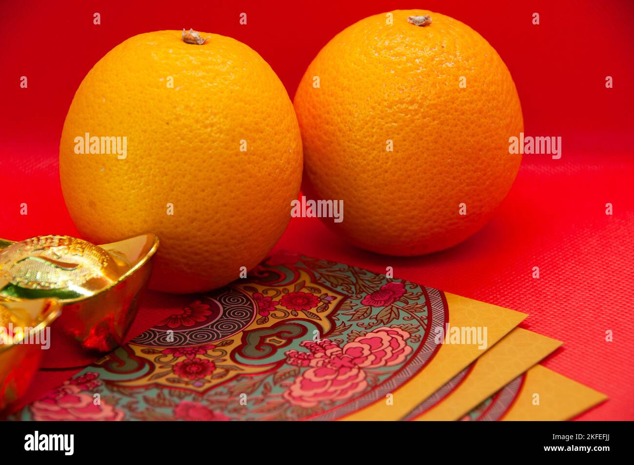 Chinese New Year decoration with oranges, colorful packets and gold ...