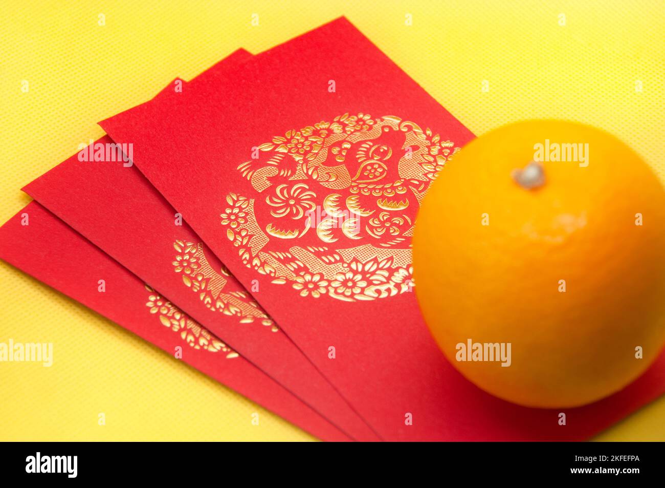 Chinese New Year red packets and orange on yellow cover background ...
