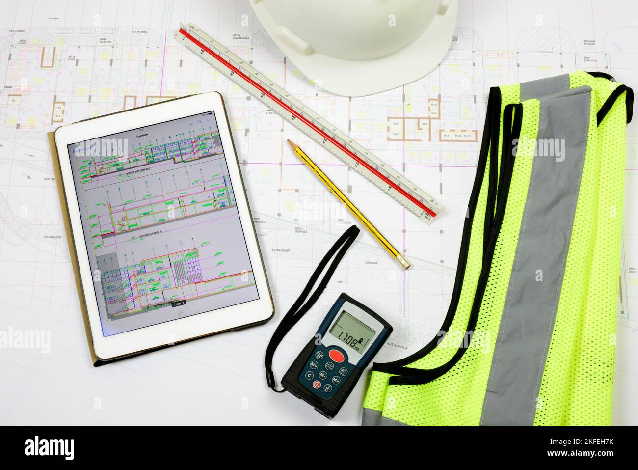 Building plan with laser measurement device, pencil, ruler, drawing ...