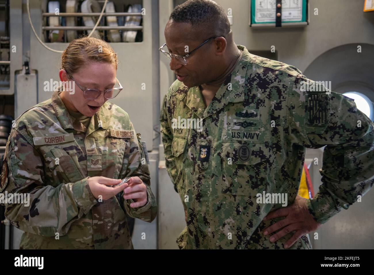 A U.S. Air Force Airman is coined by U.S. Navy Fleet Master Chief ...