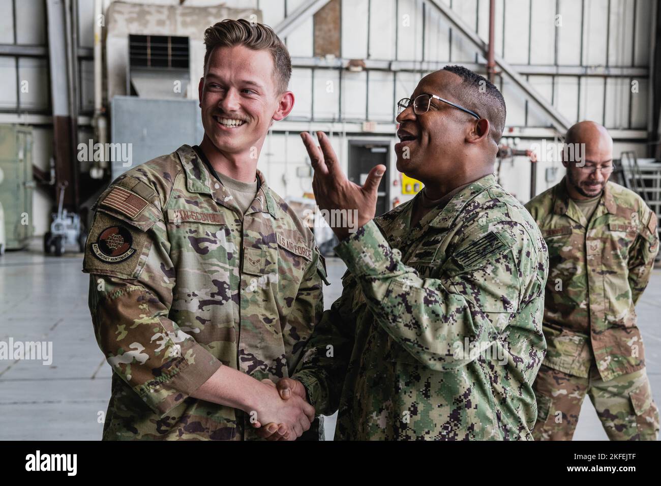 A U.S. Air Force Airman is coined by U.S. Navy Fleet Master Chief ...