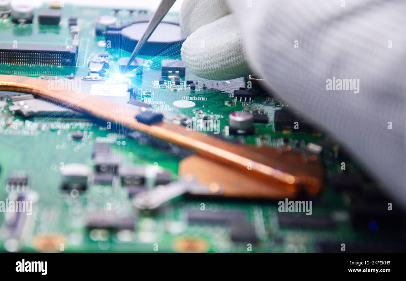 Side view as mechanic fixing motherboard Stock Photo - Alamy