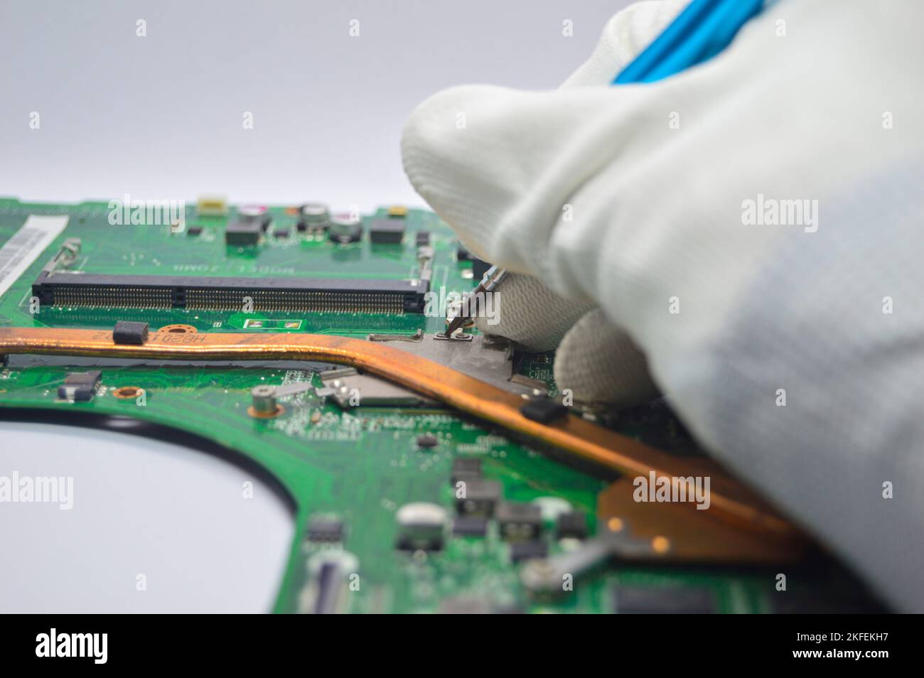 Side view as mechanic fixing motherboard Stock Photo - Alamy