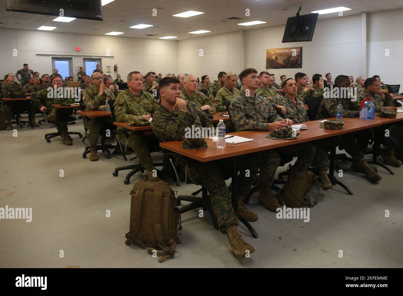 Joint force service members listen during a brief for the Information ...