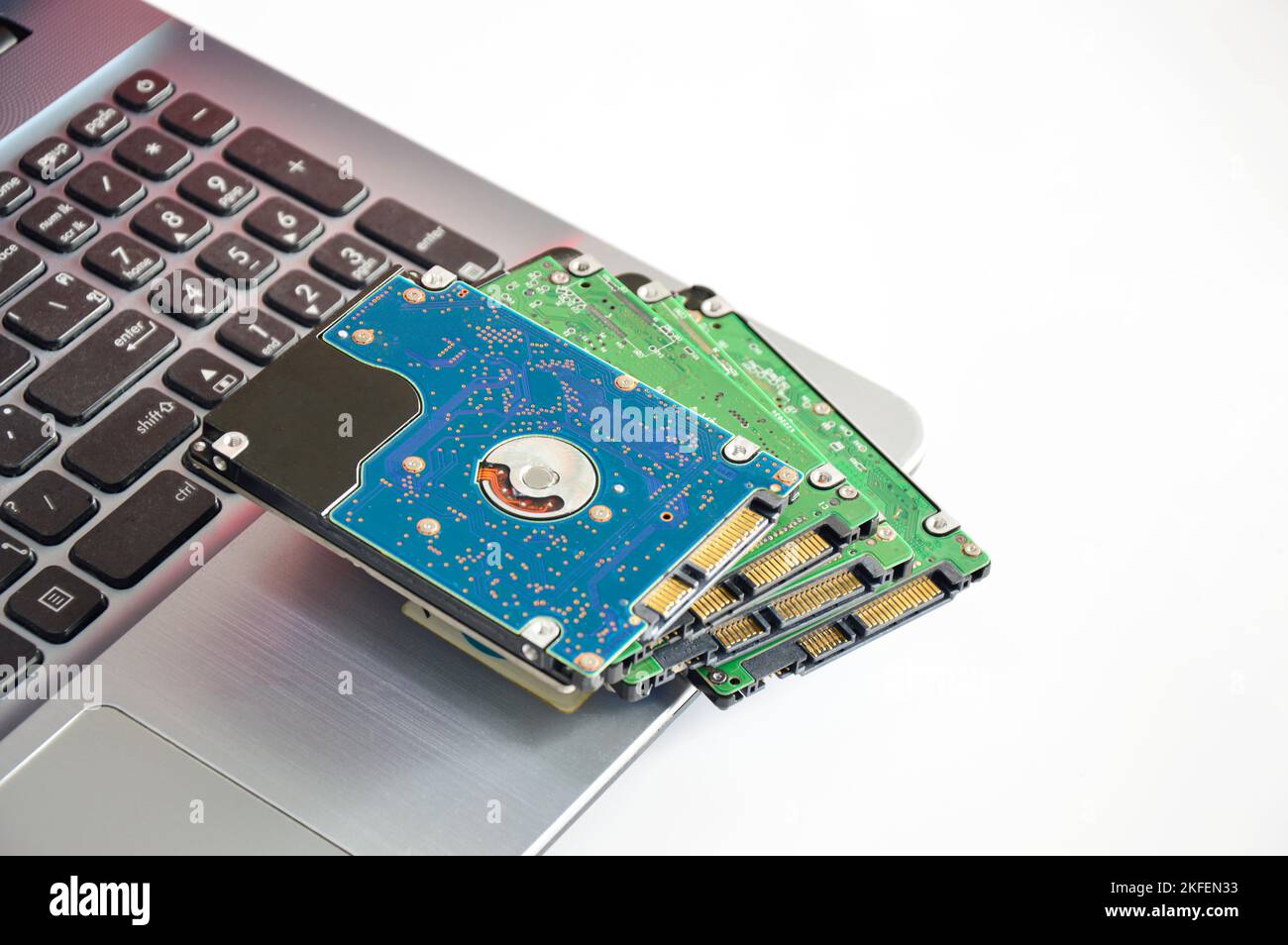 2.5 inch hard drive swivel plate placed on a laptop behind a white ...