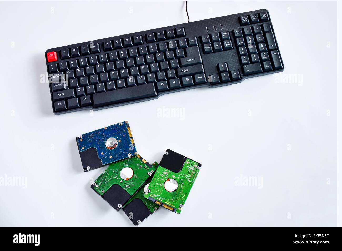 2.5-inch hard drive, swivel plate and keyboard keys on a white ...
