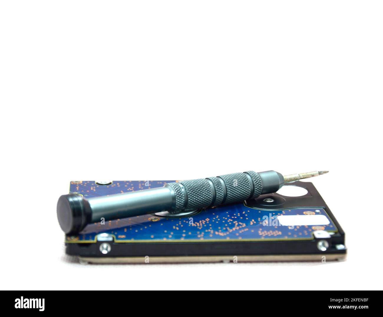 Close-up view of a screwdriver placed on a 2.5 inch hard disk viewed ...