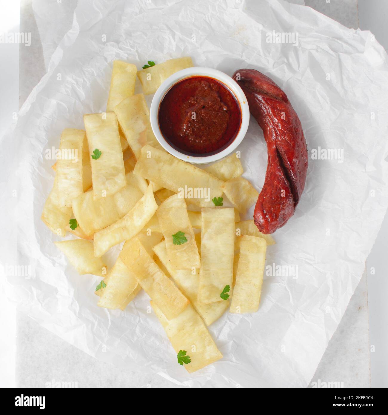 slices of fried yam, sausage and sauce, slices fried yam and stew on ...