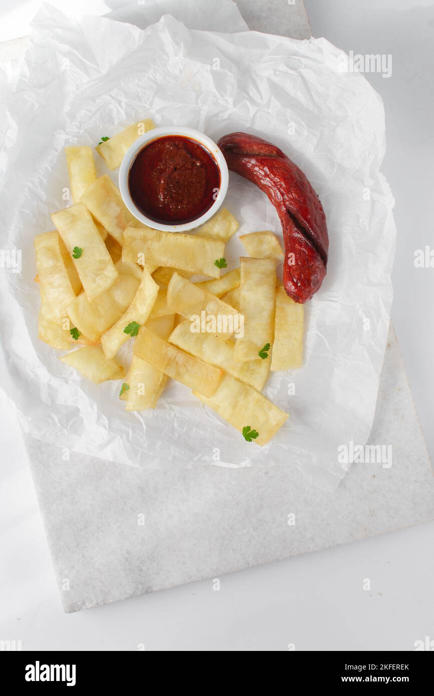 slices of fried yam, sausage and sauce, slices fried yam and stew on ...