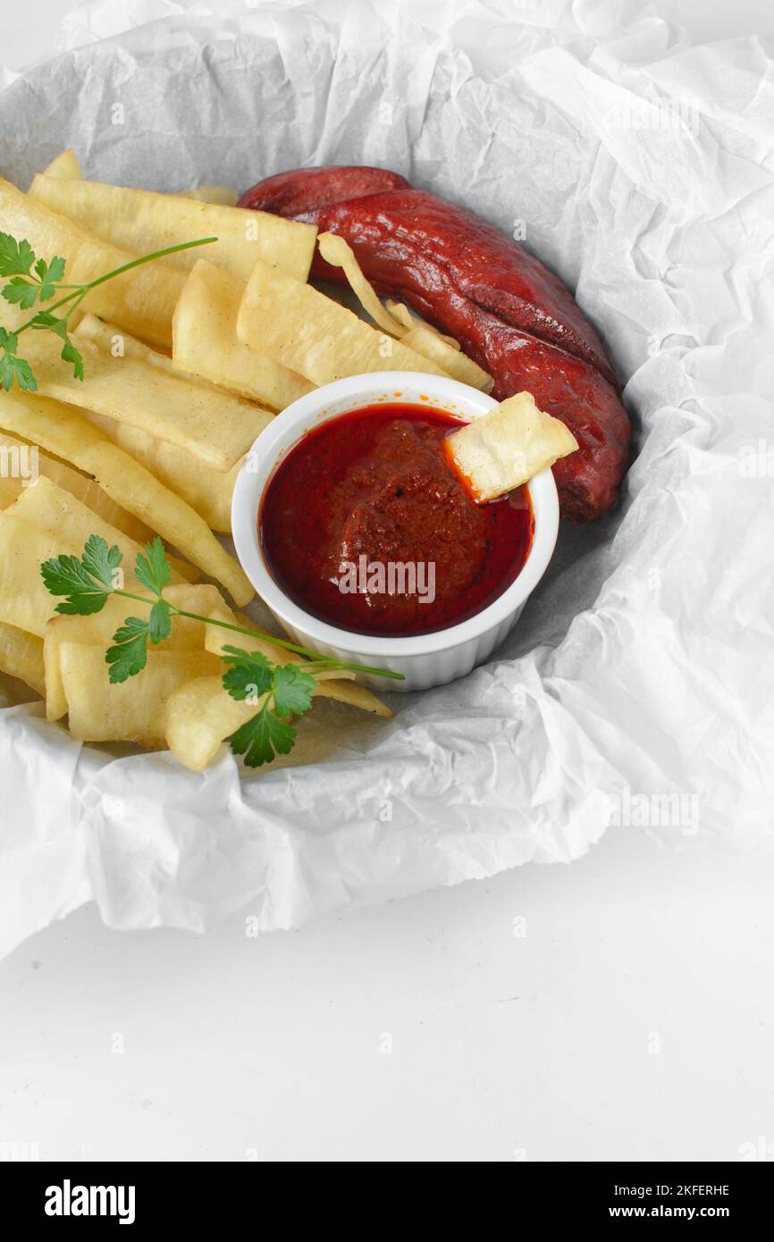 slices of fried yam, sausage and sauce, slices fried yam and stew on ...