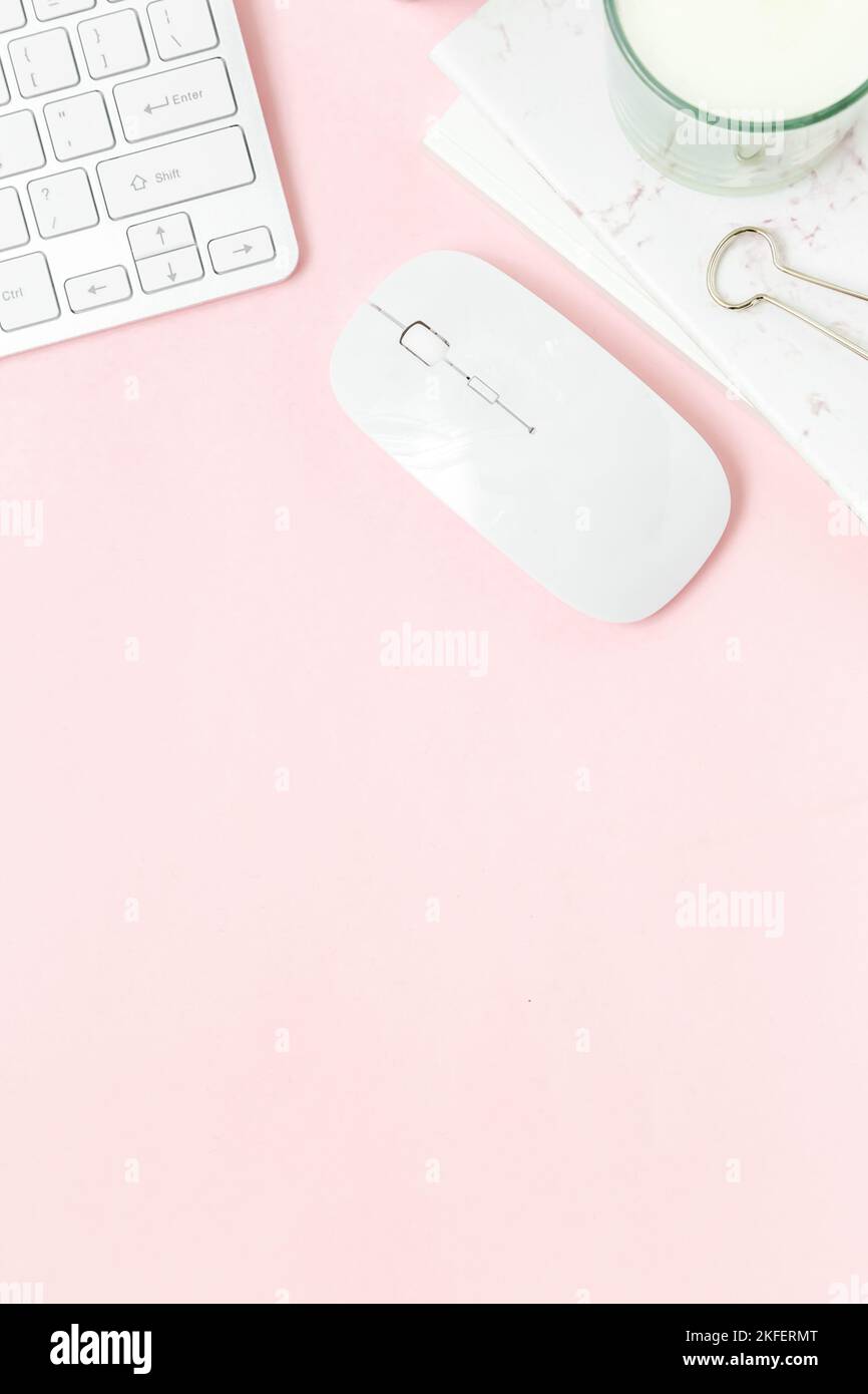 A feminine woman workspace, with a silver keyboard of a computer on a ...