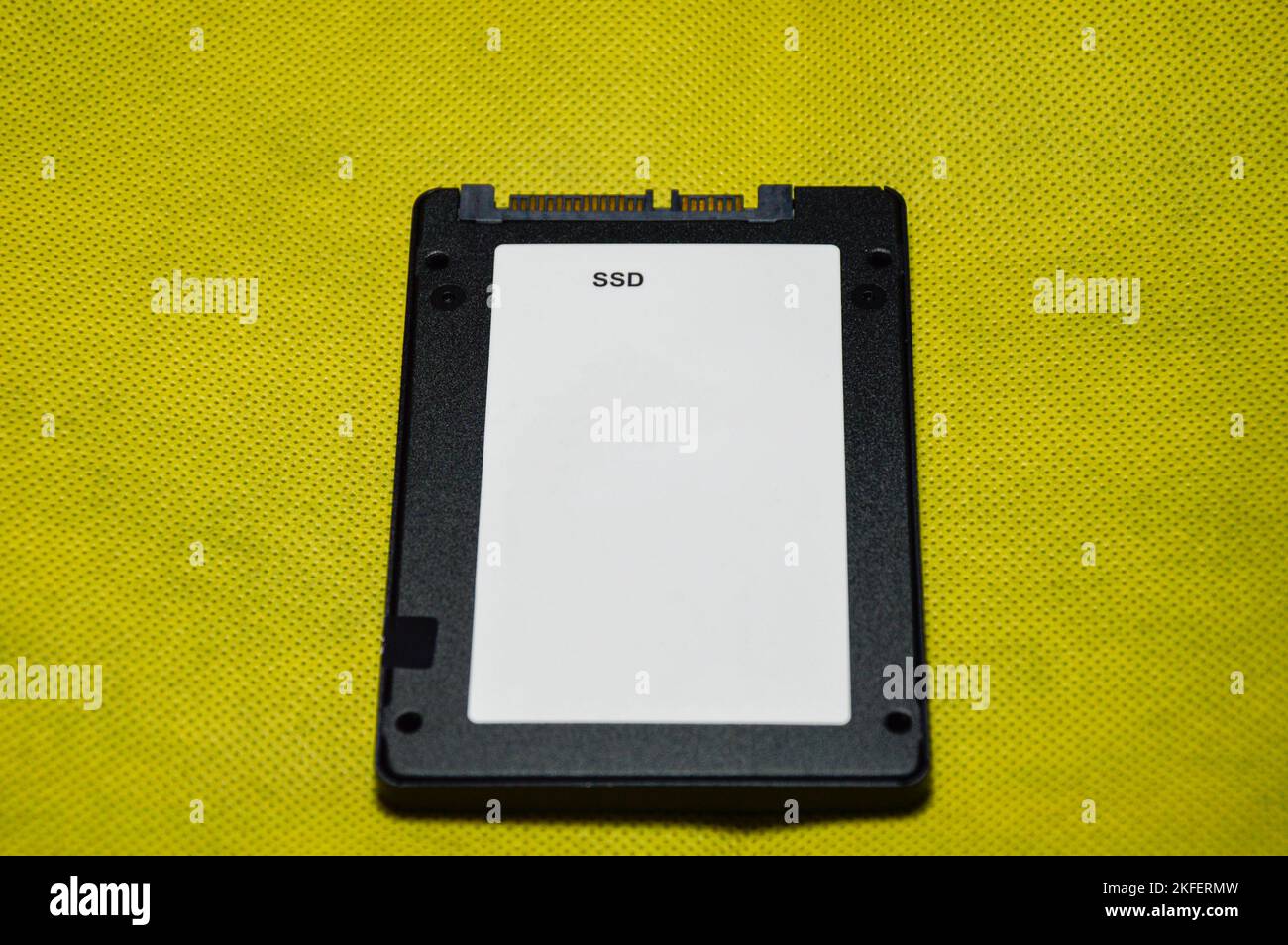2.5 inch SSD hard drive laying on a yellow background Stock Photo - Alamy