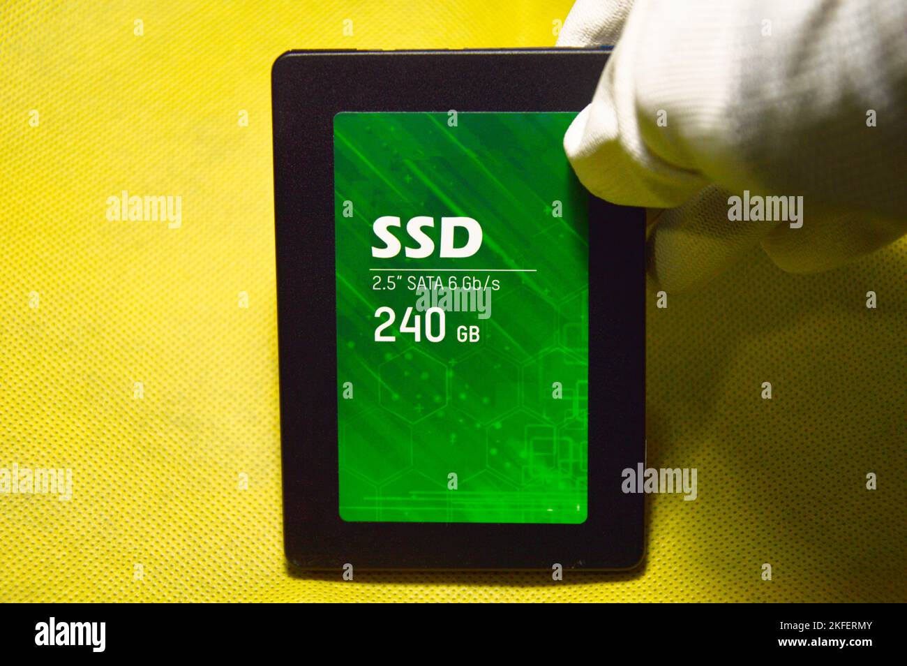 2.5 inch SSD hard drive laying on a yellow background Stock Photo - Alamy
