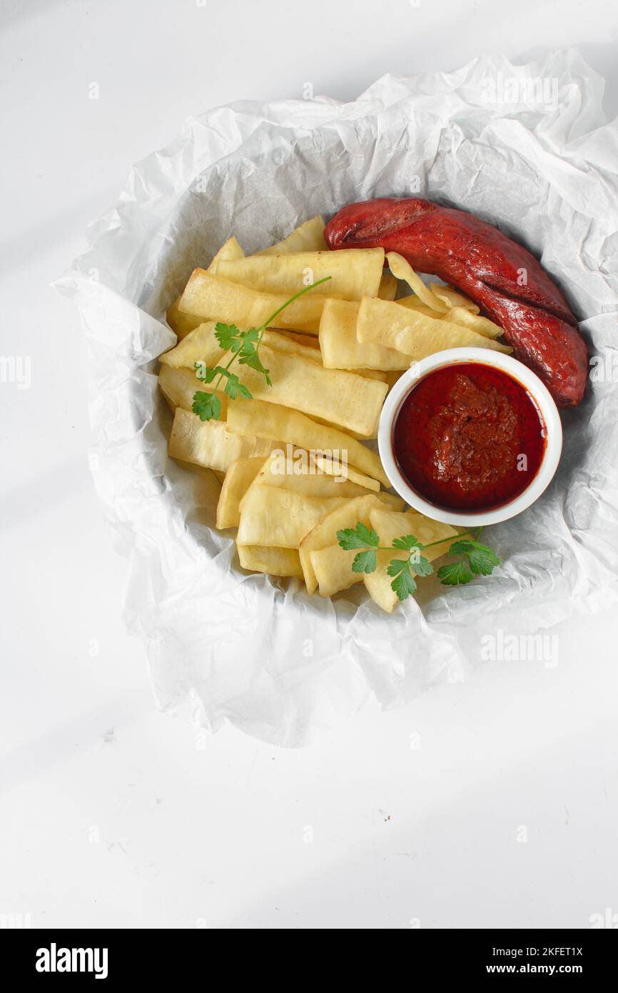 slices of fried yam, sausage and sauce, slices fried yam and stew on ...