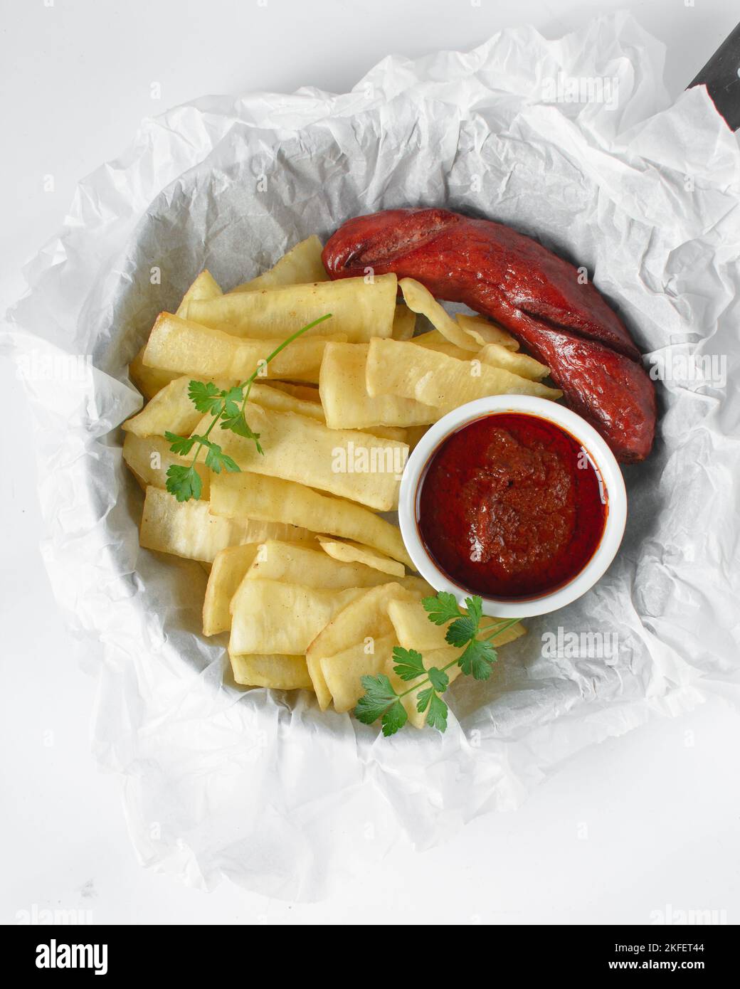 slices of fried yam, sausage and sauce, slices fried yam and stew on ...