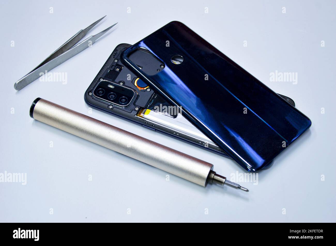 A picture of a smartphone being unpacked for repair. put on a white ...