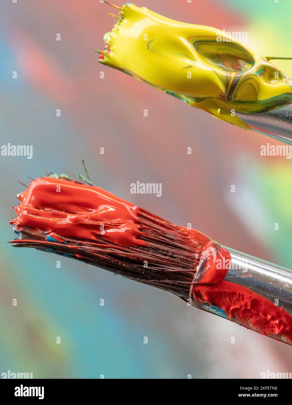 An Artist paint brushes with yellow and red colors Stock Photo - Alamy