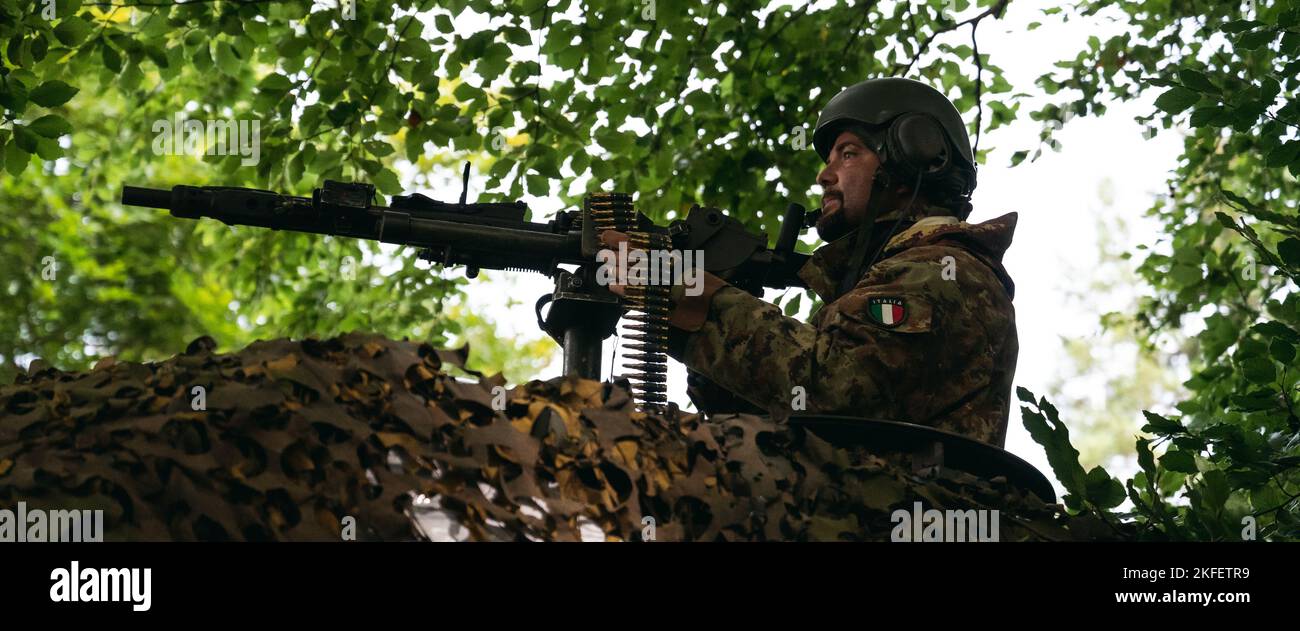 An Italian soldier with 4th Tank Regiment, Garibaldi Brigade scans the ...