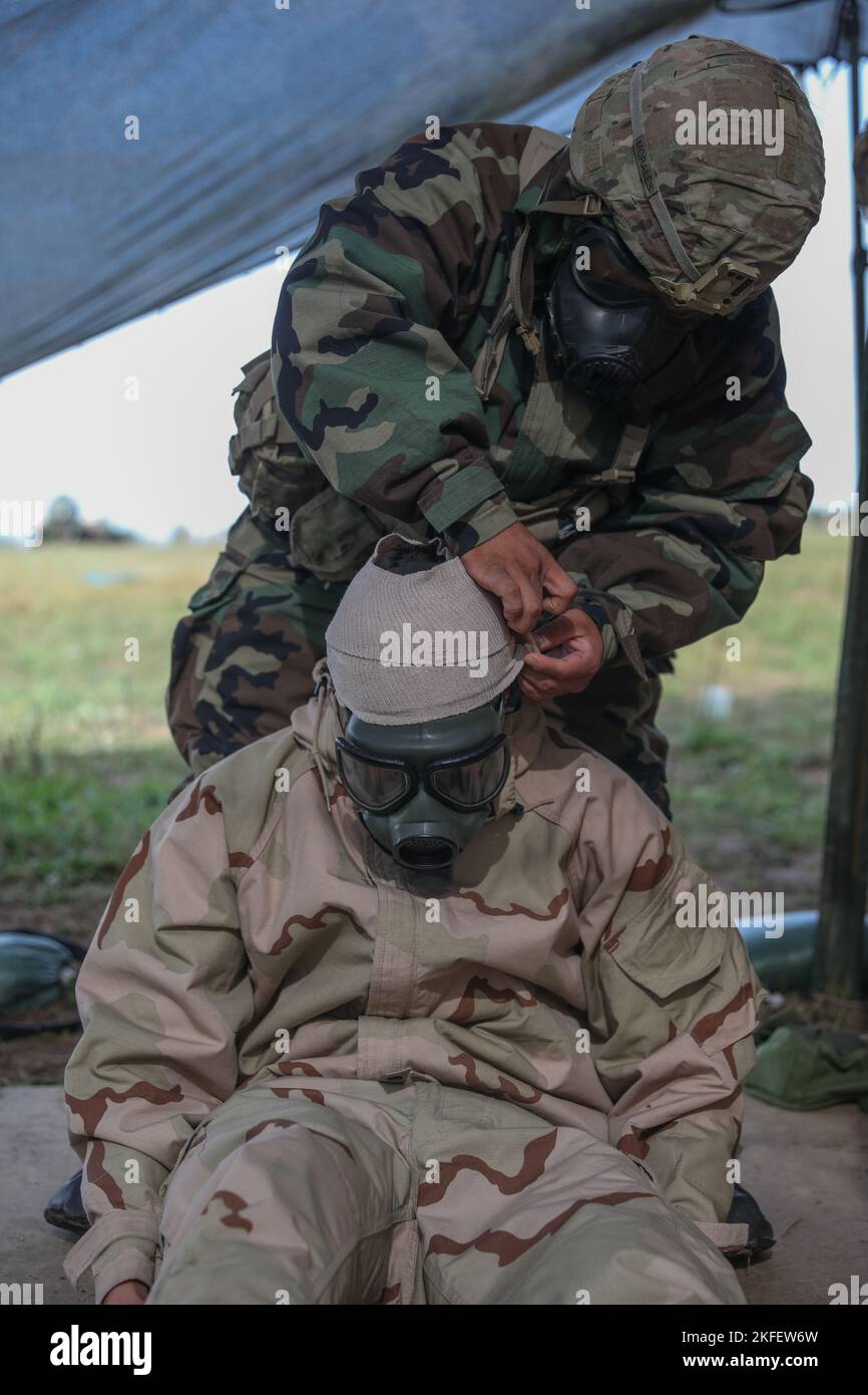 A U.S. Soldier performs a medical task during a simulated Chemical ...