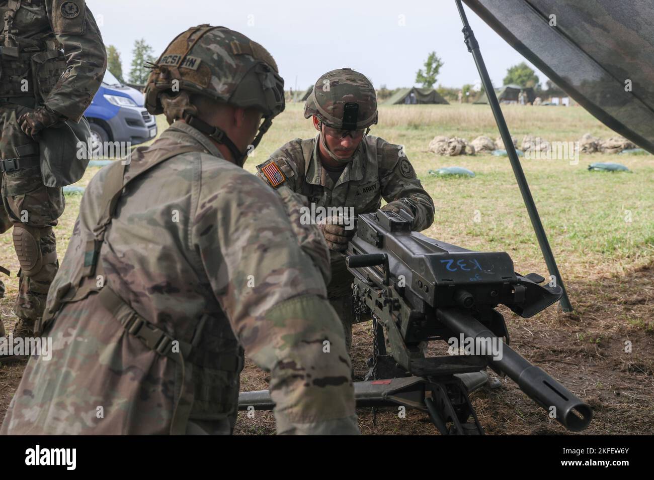 A U.S. Soldier performs weapon maintenance on a MK19 Grenade Machine ...