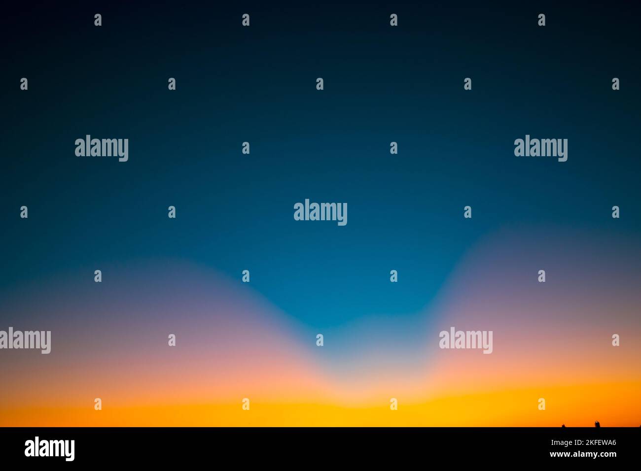 Anticrepuscular sunrays at sunset or sunrise. Blue and orange colored ...