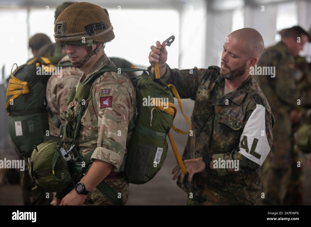 A German Jumpmaster conducts a Jumpmaster Personel Inspection (JMPI) on ...