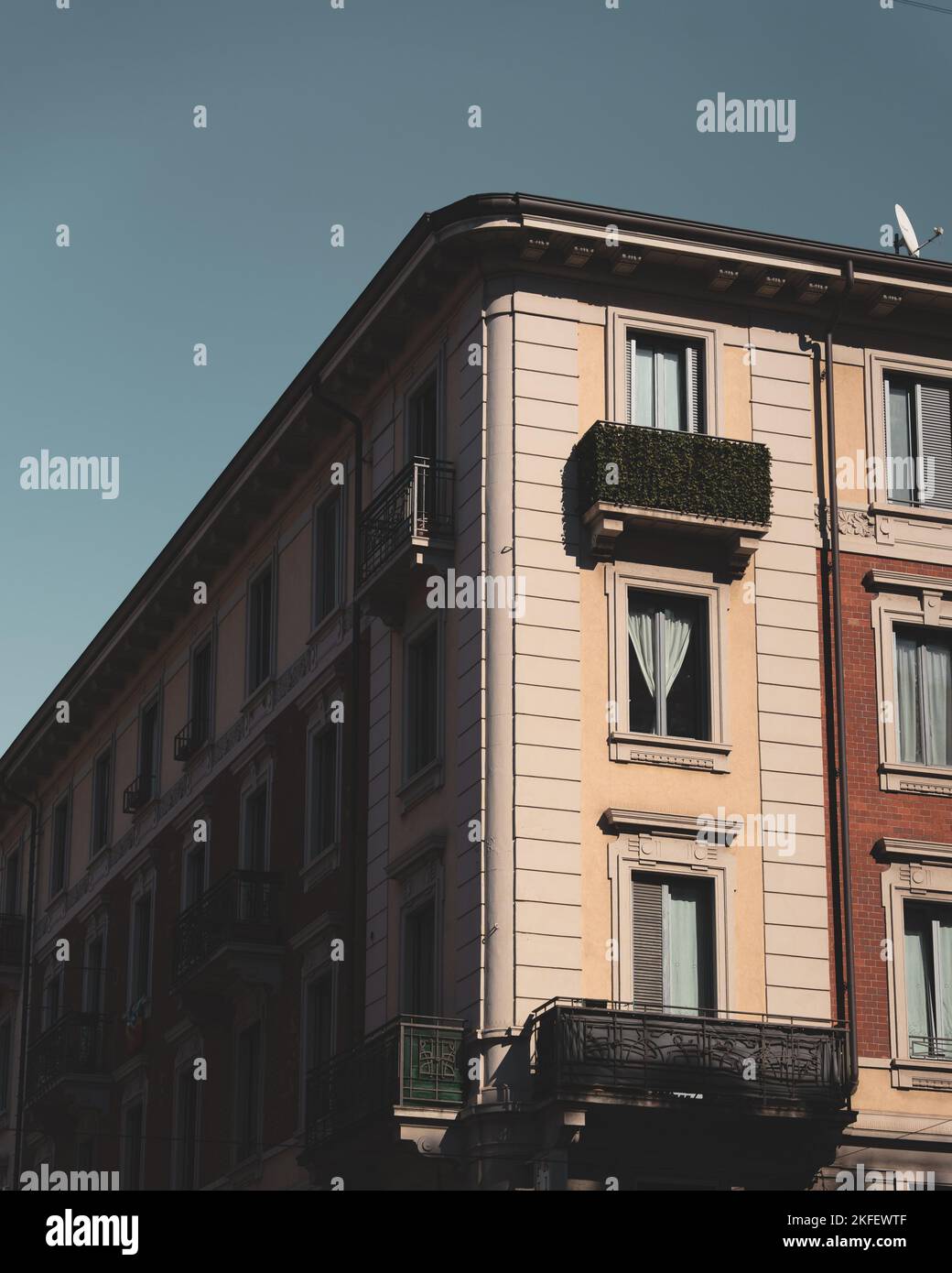 A vertical shot of the exterior of a classic building facade in Milan ...