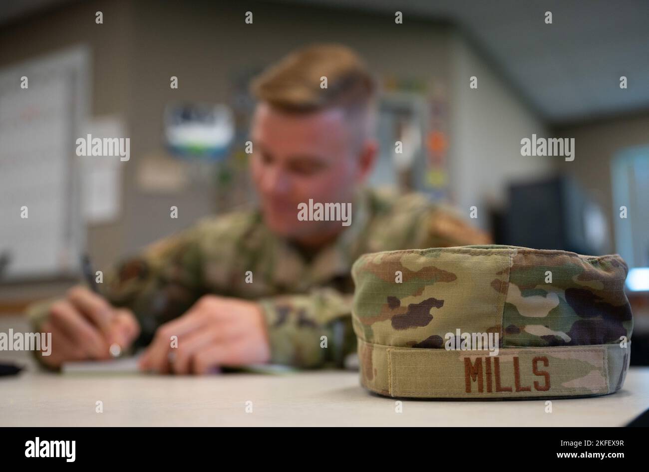 A hat rests on the desk of U.S. Air Force Airman 1st Class Austin Mills ...