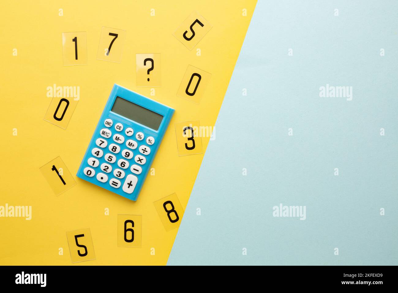 Blue digital calculator on a yellow-blue background with numbers. Space ...