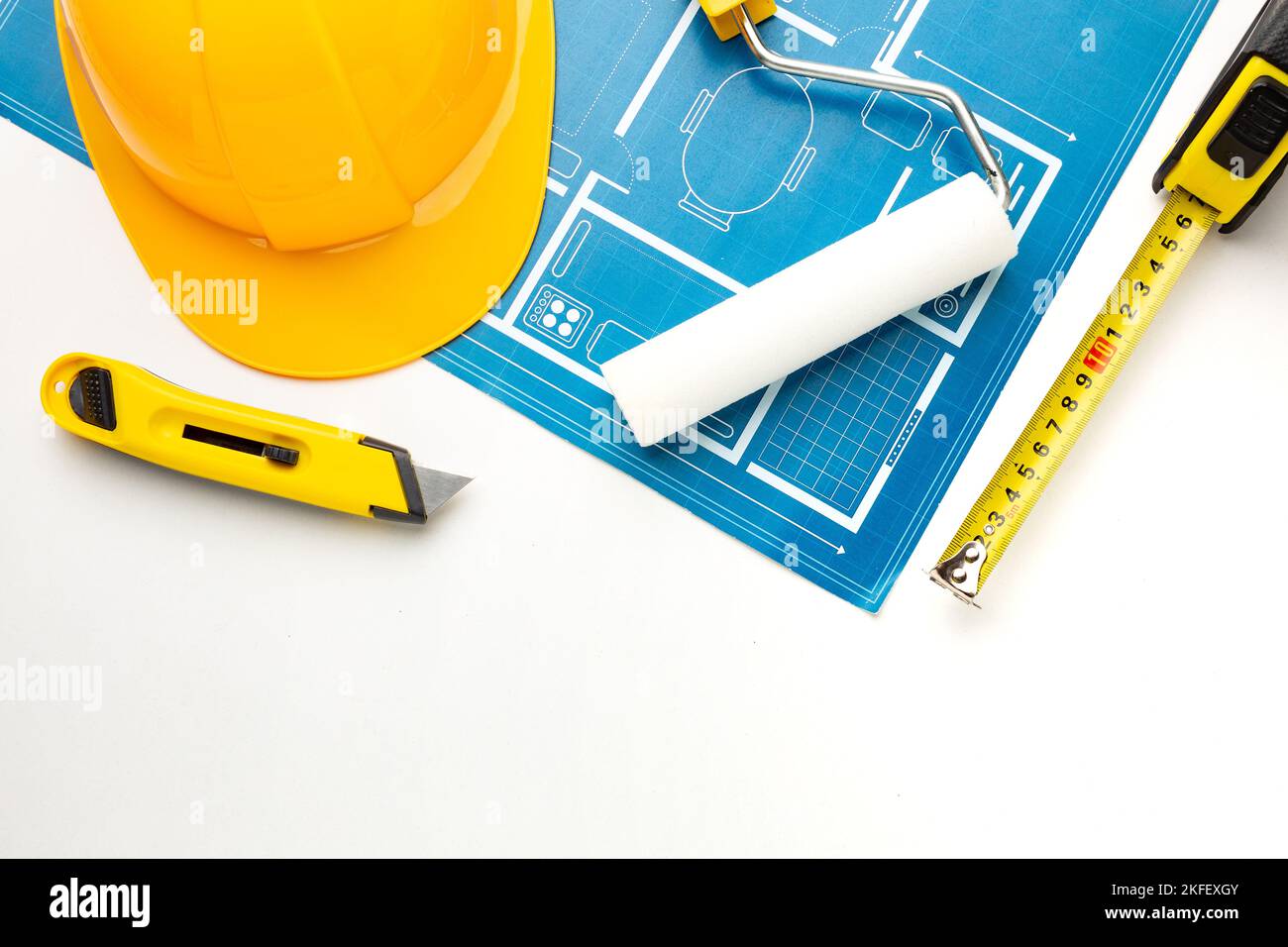 Floor plan, hard hat, roller, tape measure on a white background Stock ...
