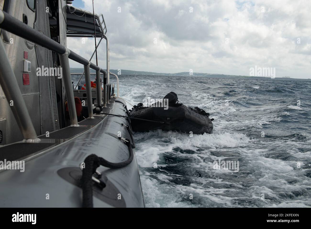 A combat rubber raiding craft is towed alongside the safe boat after ...