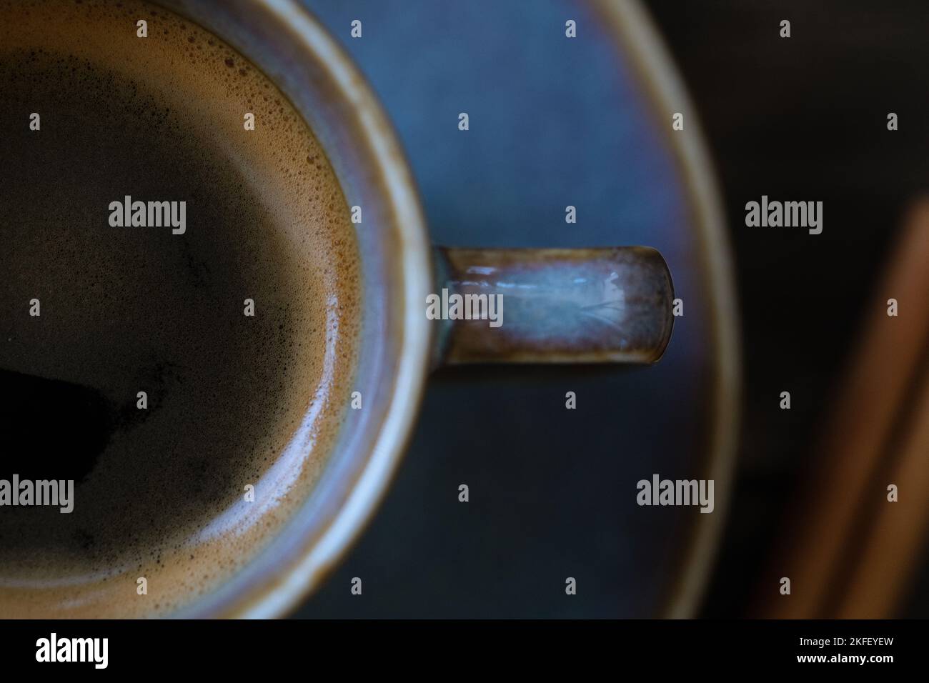 Blue coffee cup with saucer and cinnamon sticks on wooden background ...
