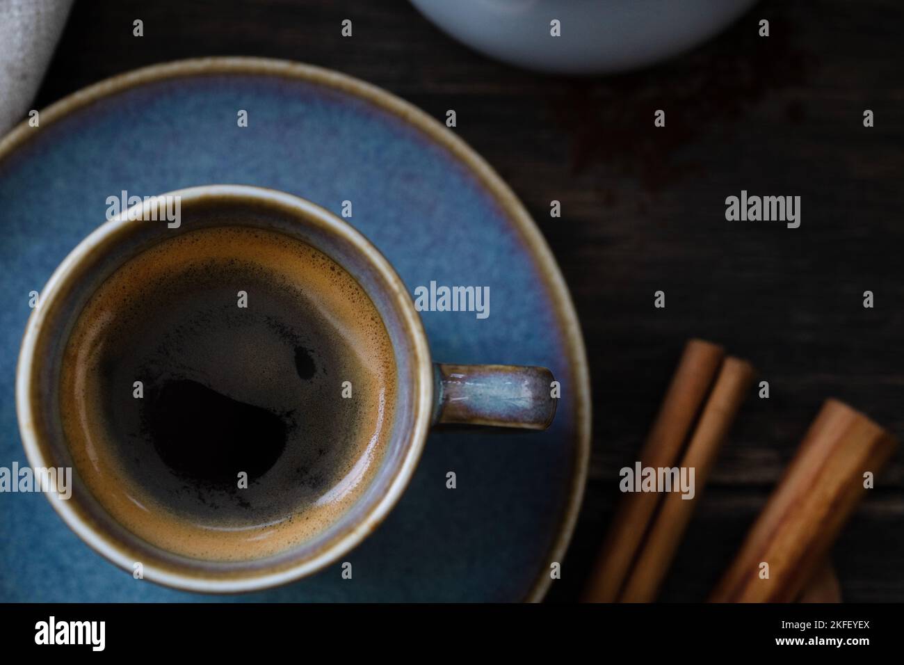Blue coffee cup with saucer and cinnamon sticks on wooden background ...