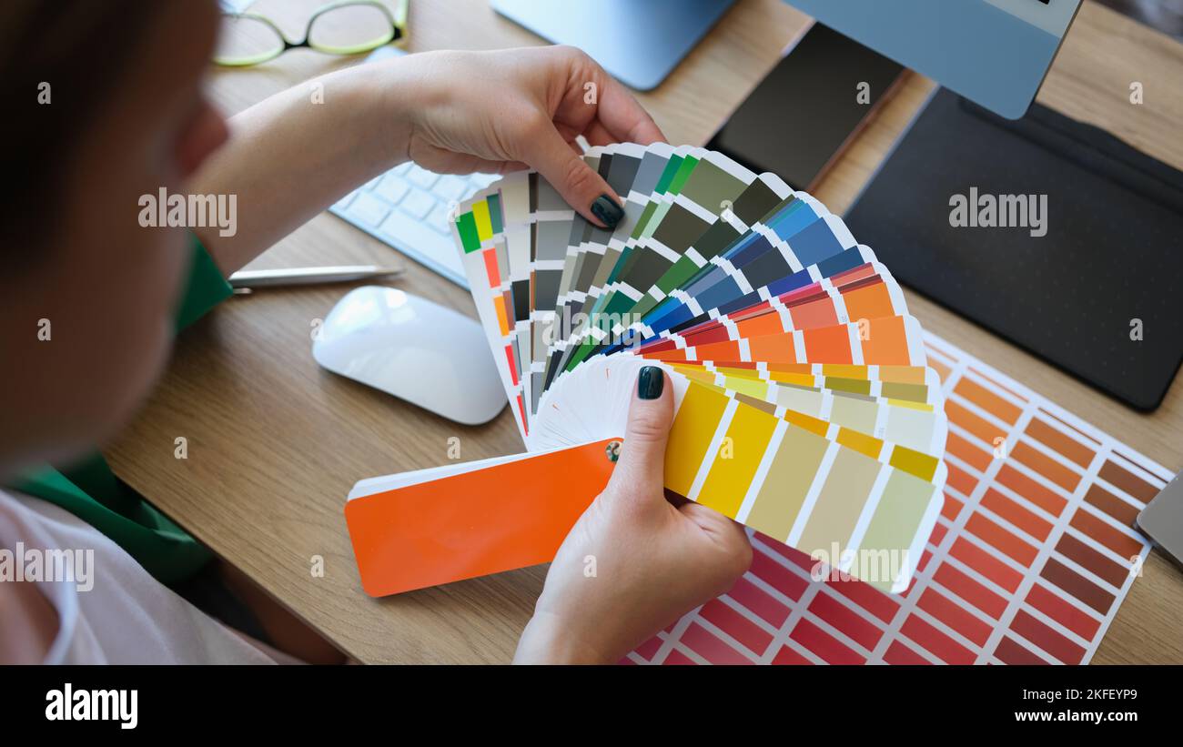 Female designer holding color samples and choosing color samples for ...