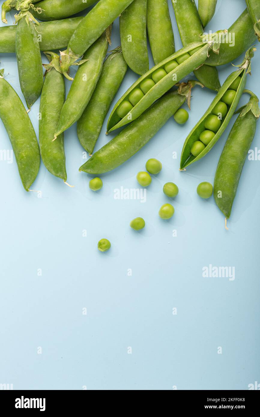 Fresh green peas on blue background. Flat lay. Top view. High quality ...