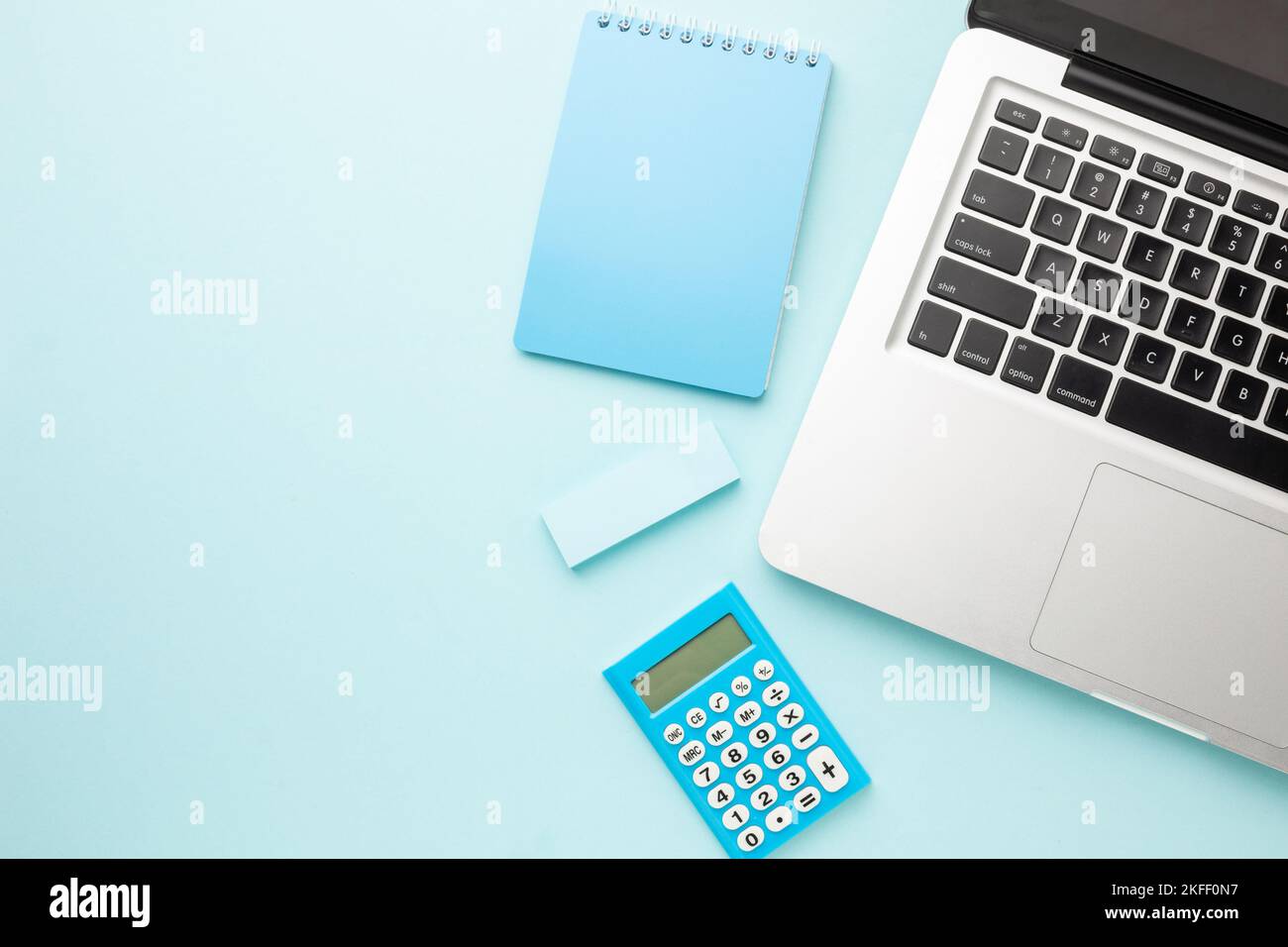 Office desk table with laptop computer, notebook, calculator, eraser ...