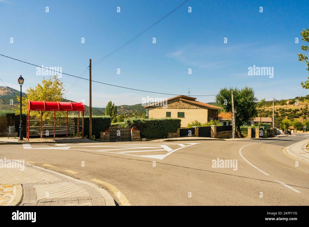 Empty Road and a red bus stop in an old town Stock Photo - Alamy