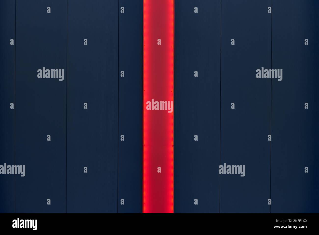 A blue panel wall with a red illuminated panel in the middle Stock ...