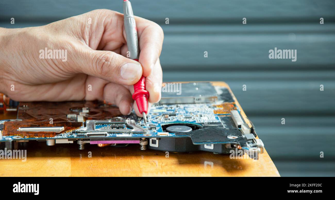 side view mechanic repairing motherboard Stock Photo - Alamy