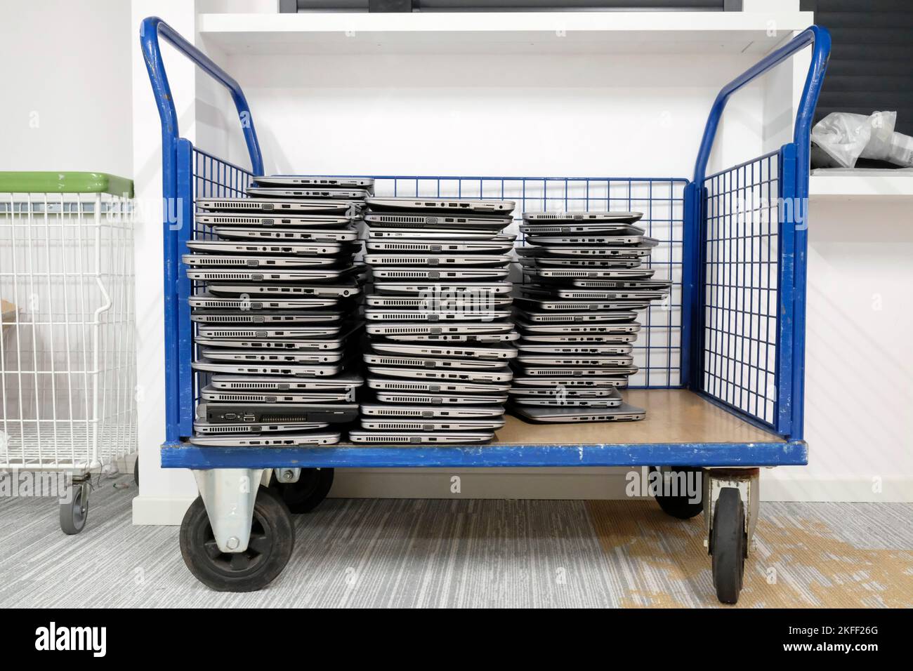 Big stacks of discarded laptops, notebooks on a trolley Stock Photo - Alamy