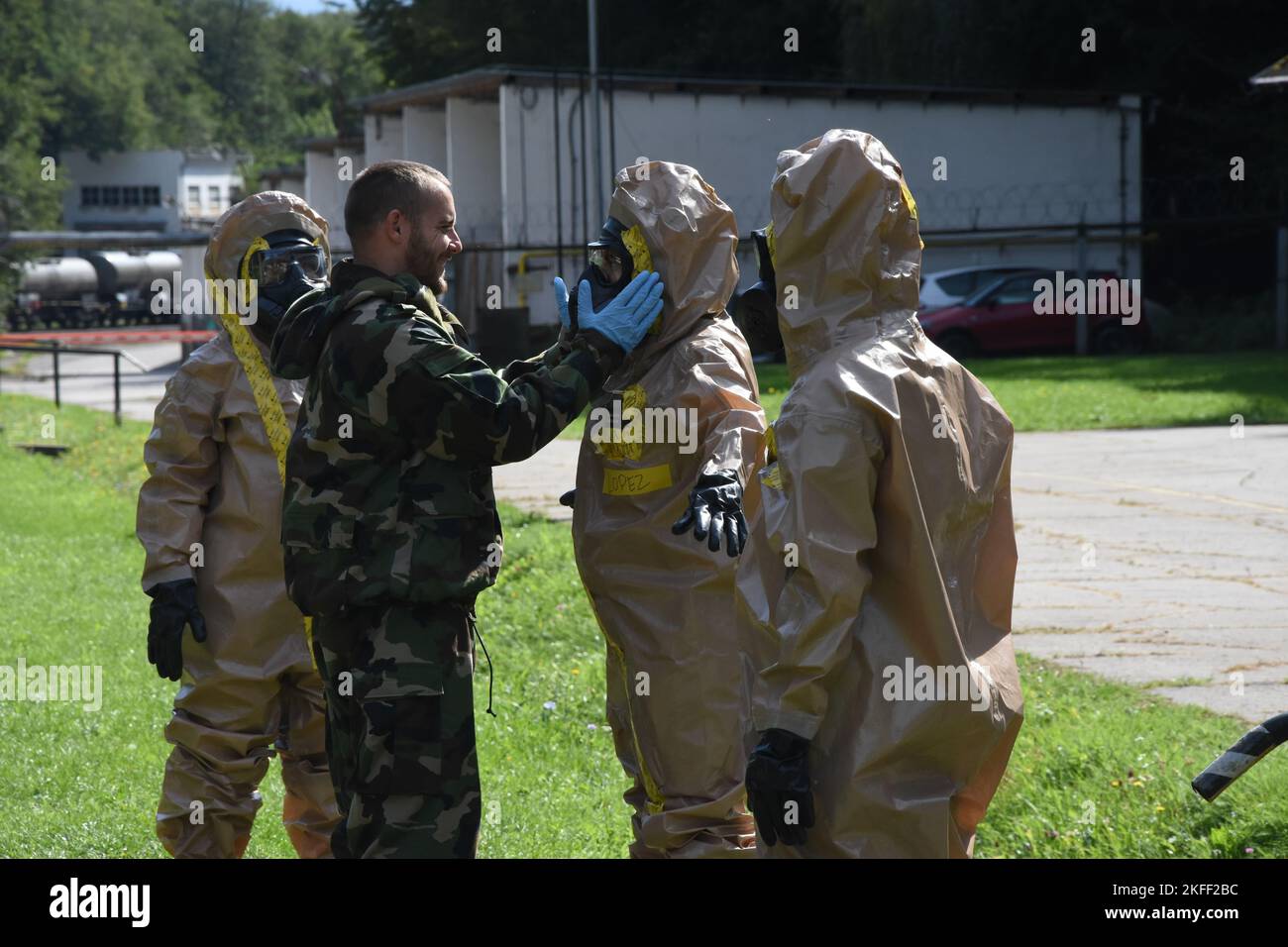 A NATO partner clears the gas mask of U.S. Army Sgt. Ashley Lopez, a ...