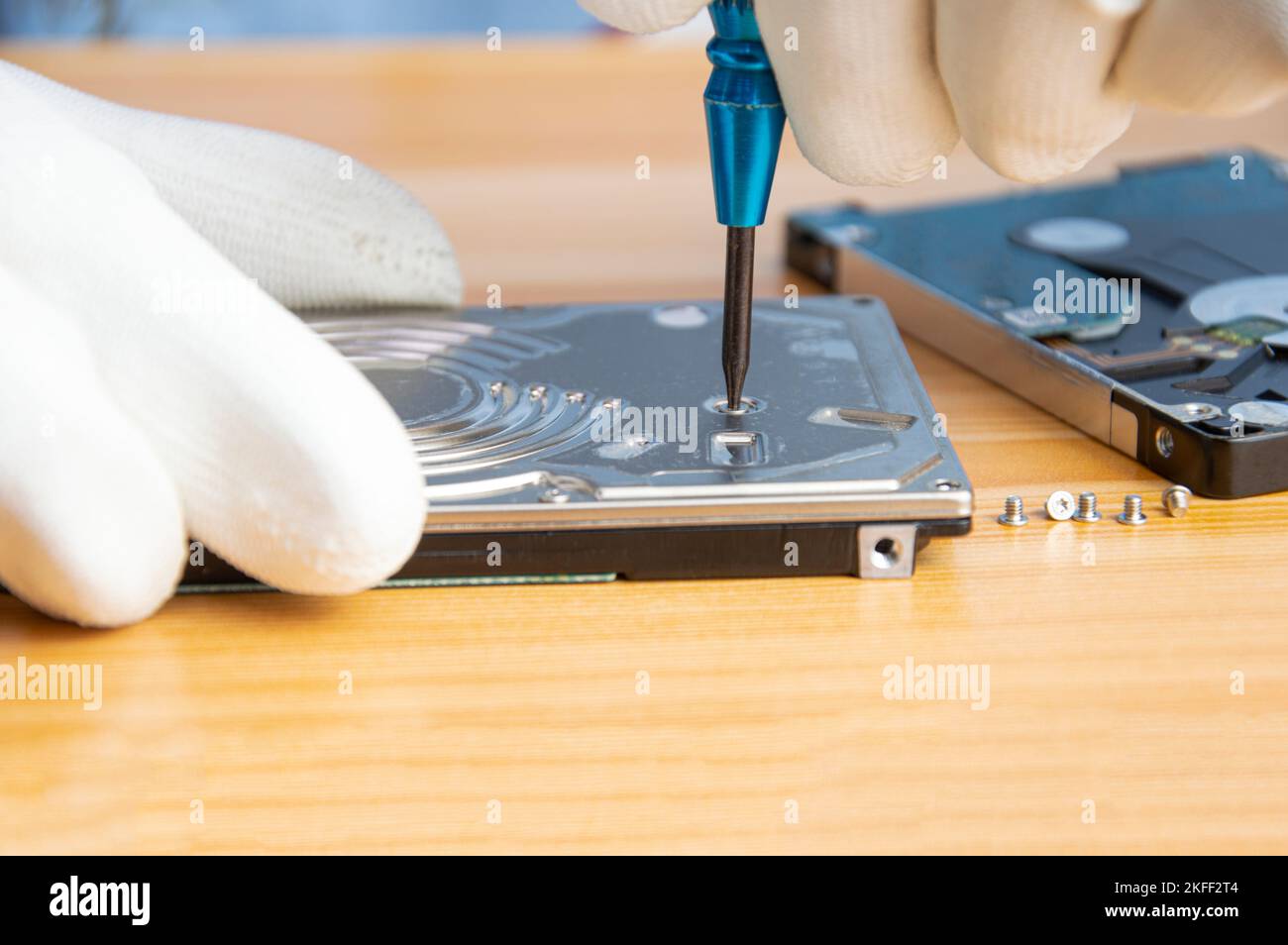 mechanic repairing hard drive, hard drive It is a device for storing ...