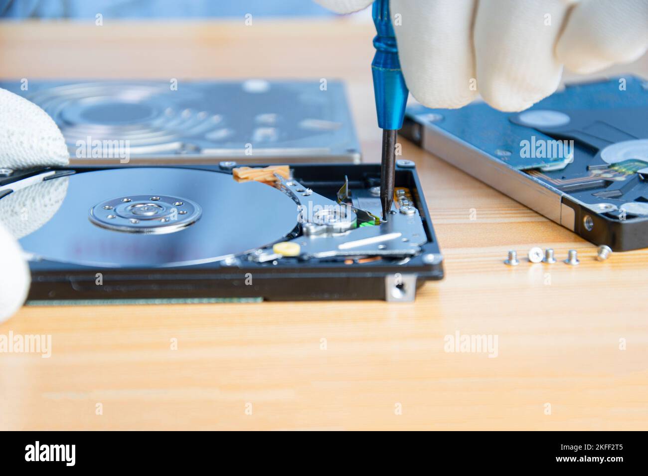 mechanic repairing hard drive, hard drive It is a device for storing ...