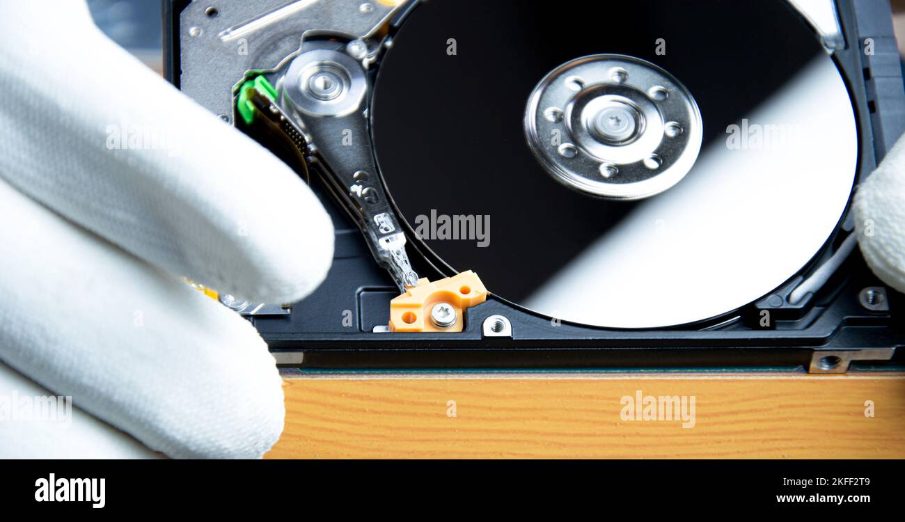mechanic repairing hard drive, hard drive It is a device for storing ...