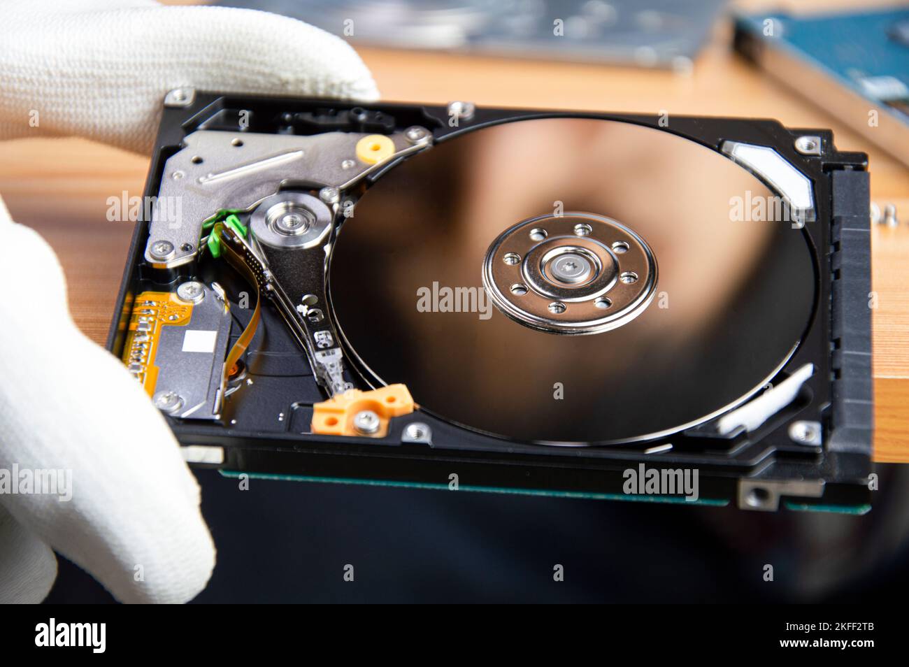 mechanic repairing hard drive, hard drive It is a device for storing ...