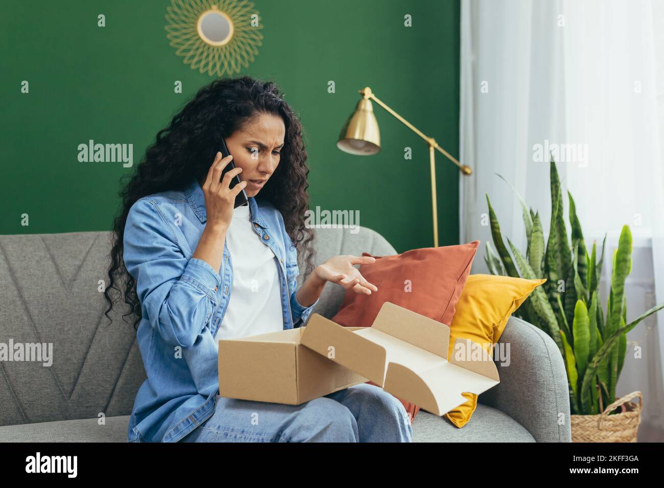 Nervous young beautiful Latin American woman is begging on the phone at ...