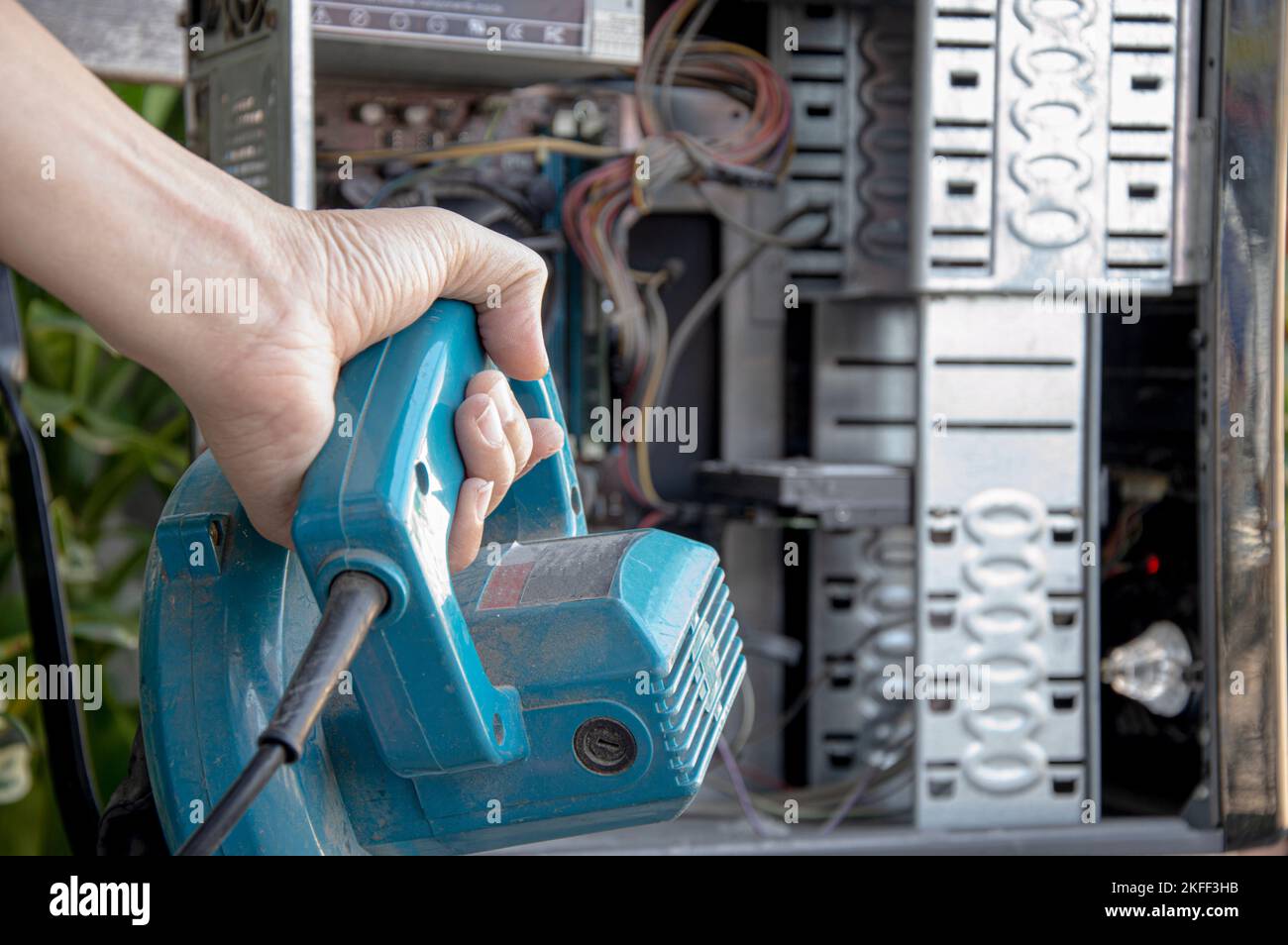 Cleaning a dusty computer with a blower Stock Photo - Alamy